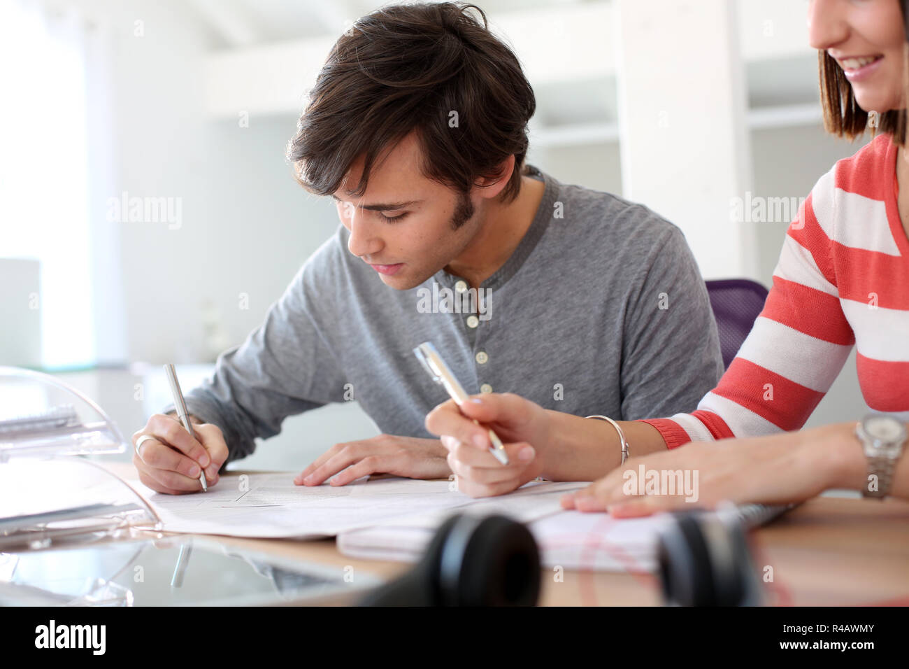 Student writing an exam in class Stock Photo - Alamy