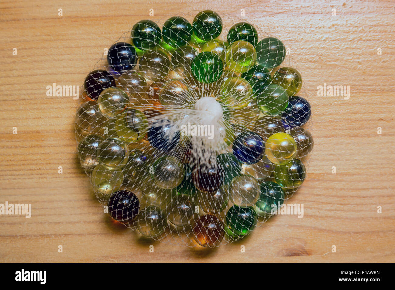 Grouup of colorful glass marbles in net Stock Photo - Alamy