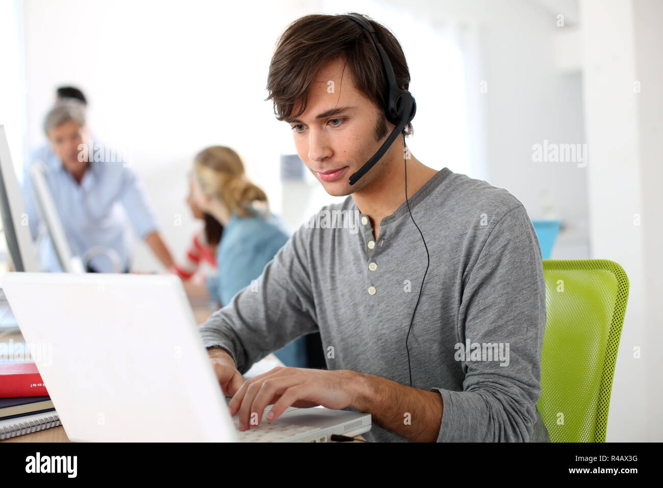 Student with headset on doing English language test Stock Photo - Alamy