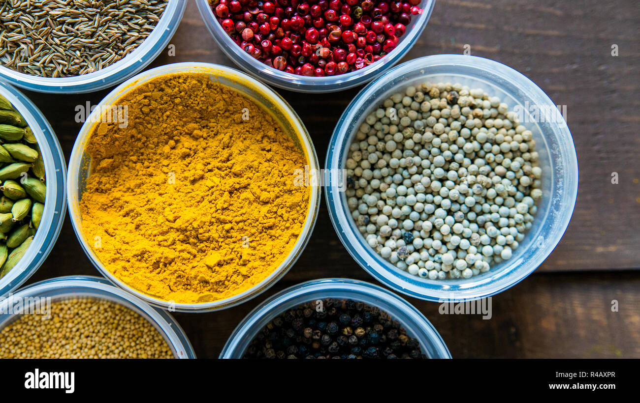 Various colorful spices in plastic containers top view Stock Photo - Alamy