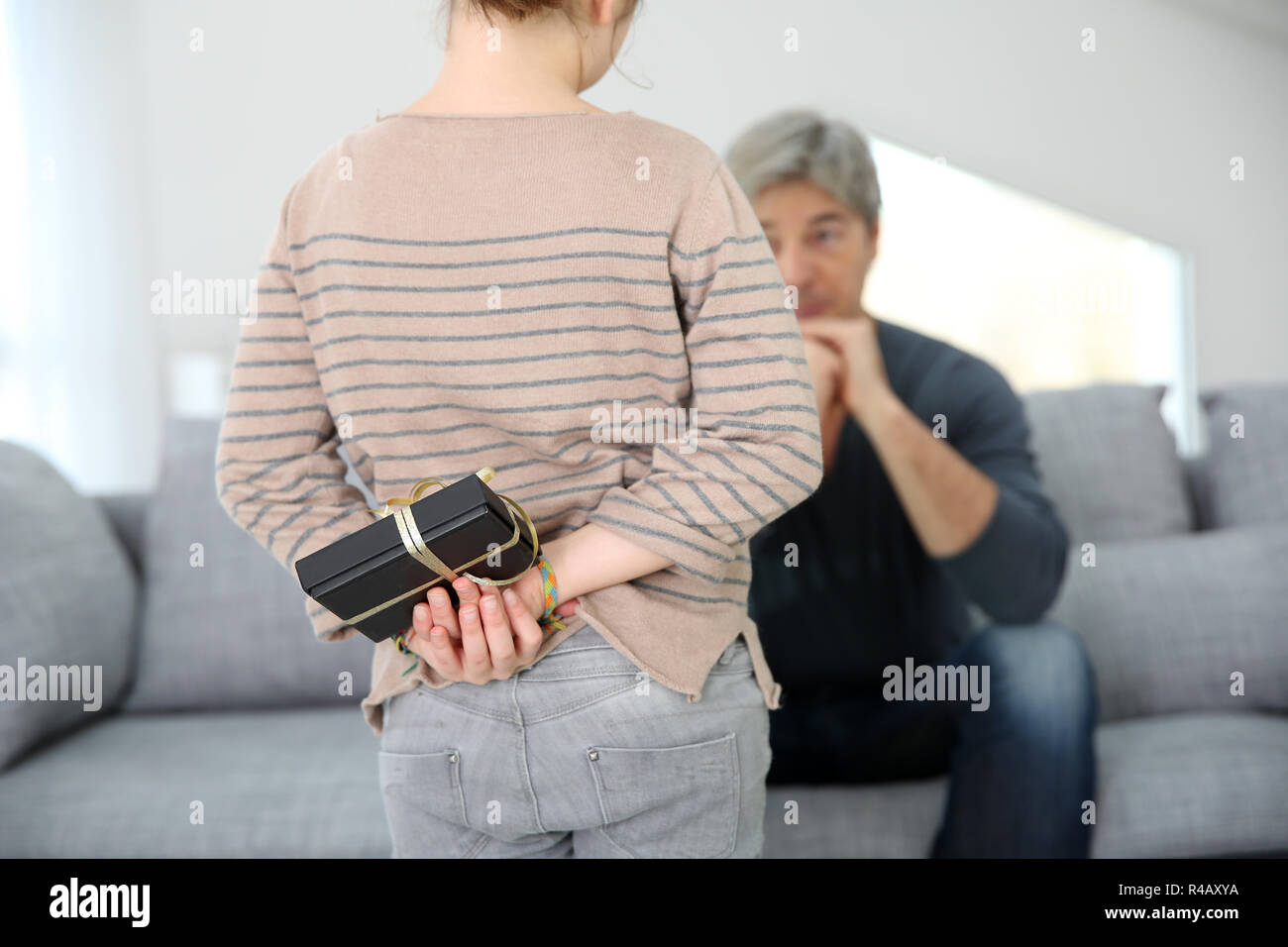 Girl giving present to daddy on father's day Stock Photo - Alamy