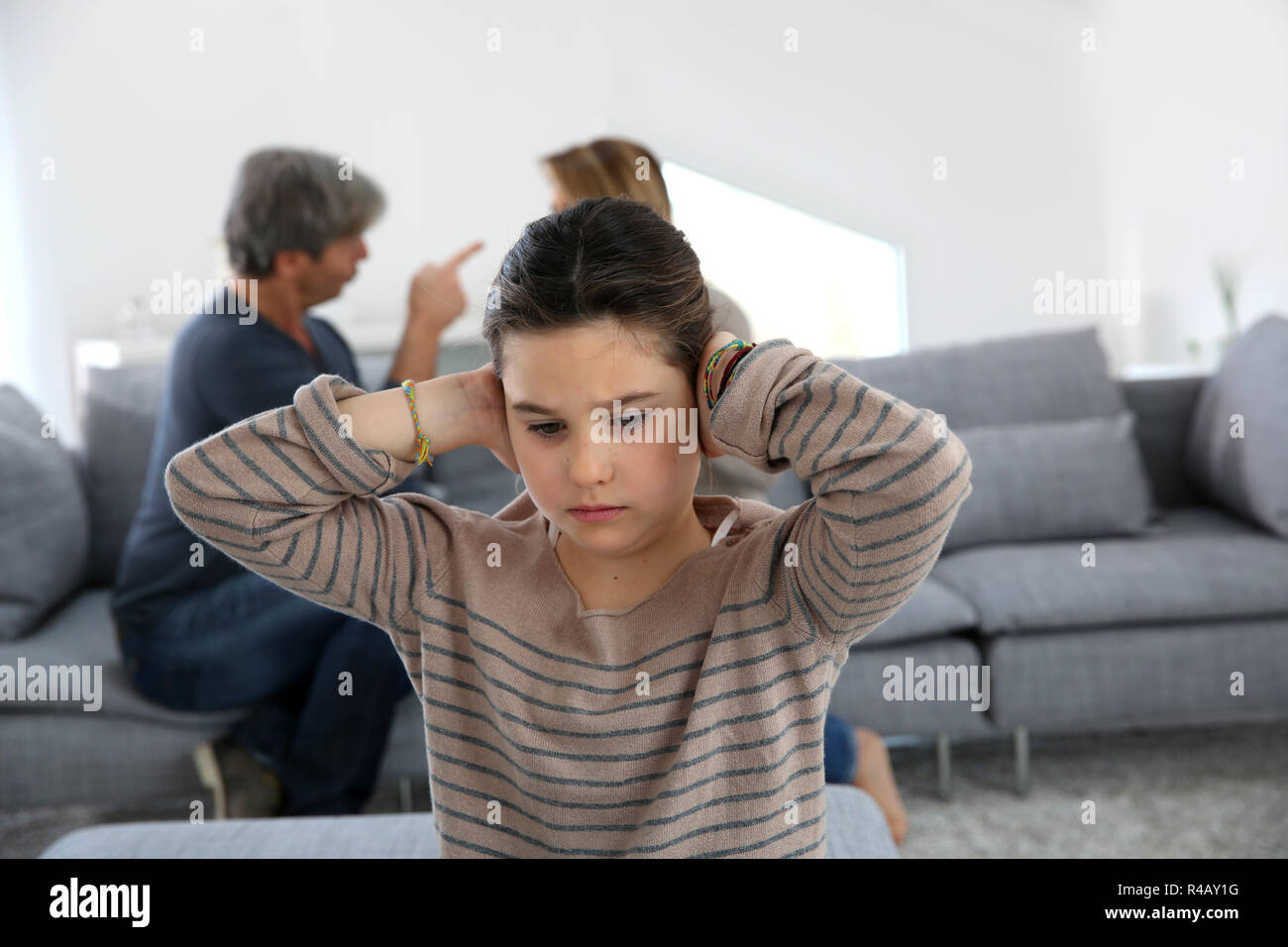 Parents fighting and daughter being upset Stock Photo - Alamy