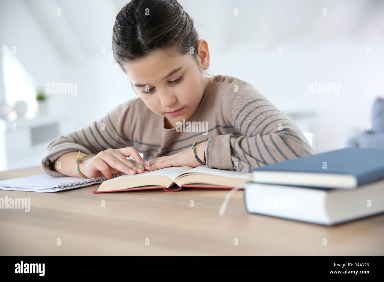 Portrait of 8-year-old girl doing homework Stock Photo - Alamy
