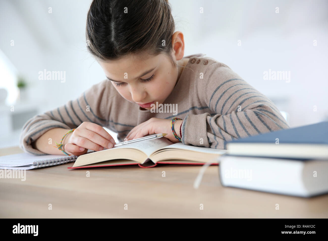 Portrait of 8-year-old girl doing homework Stock Photo - Alamy