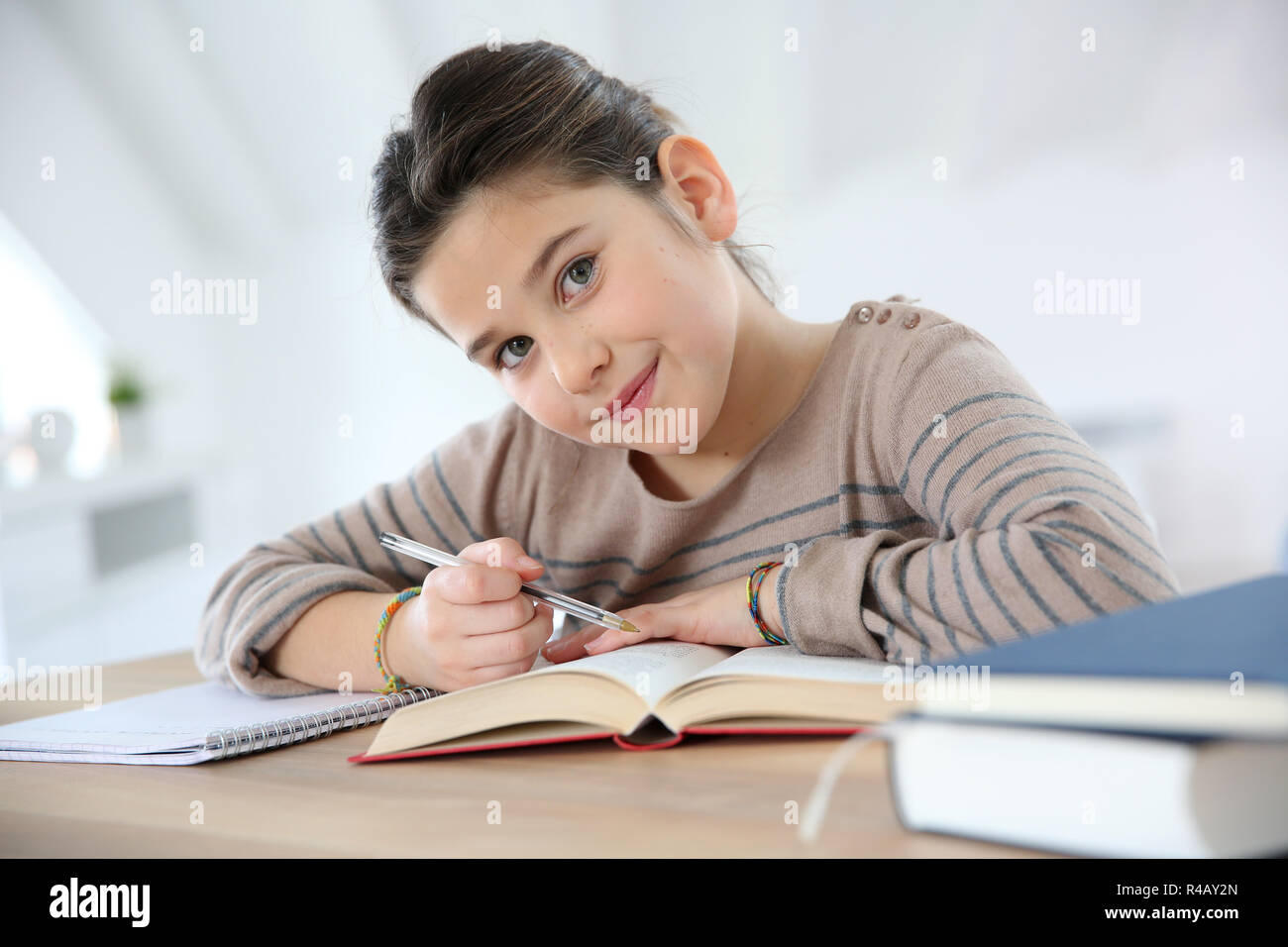 Portrait of 8-year-old girl doing homework Stock Photo - Alamy