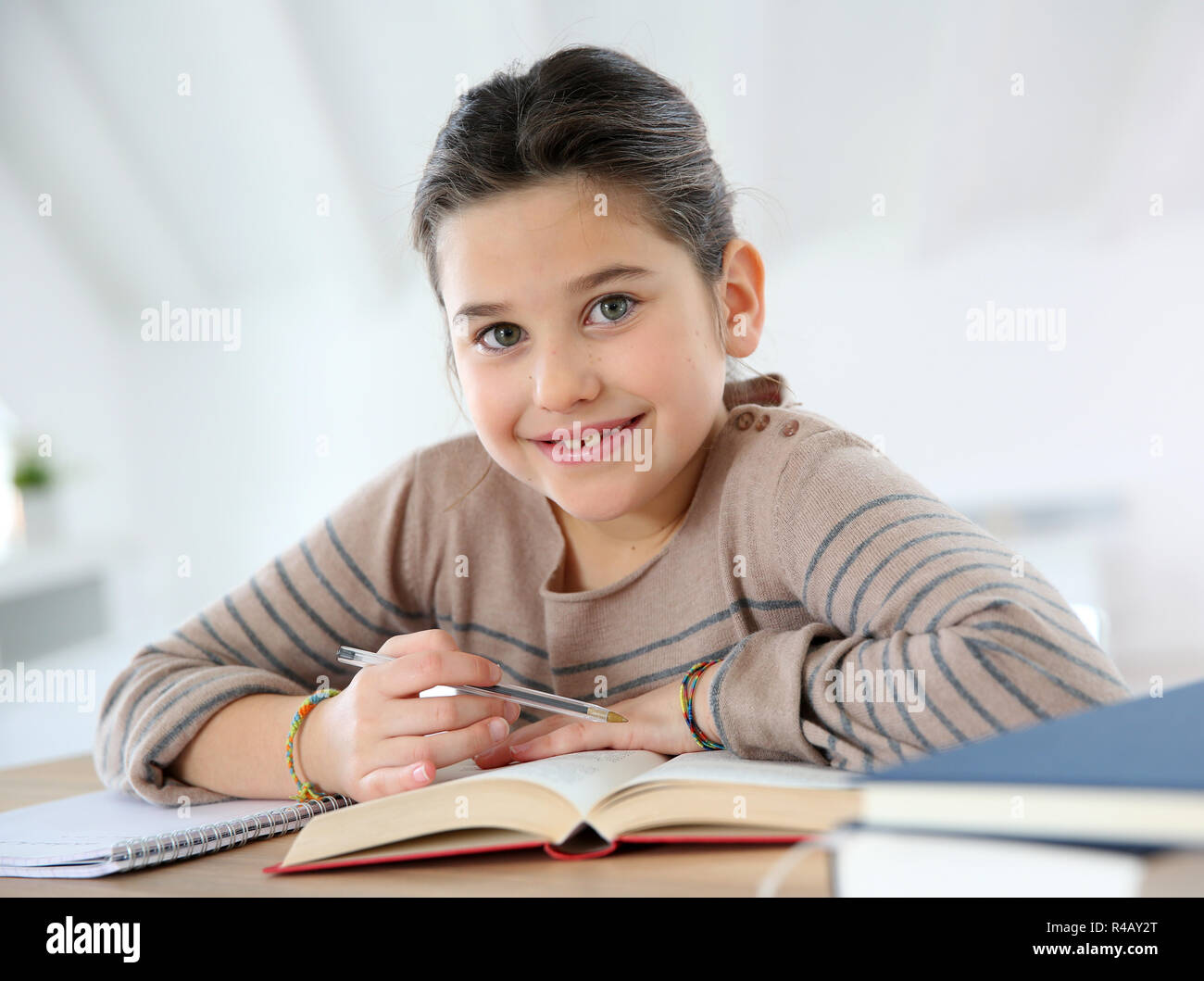 Portrait of 8-year-old girl doing homework Stock Photo - Alamy