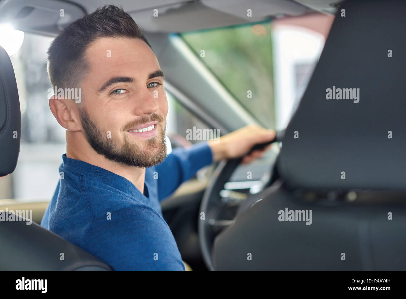 Portrait of hansome brunette man with beard looking at back. Young ...