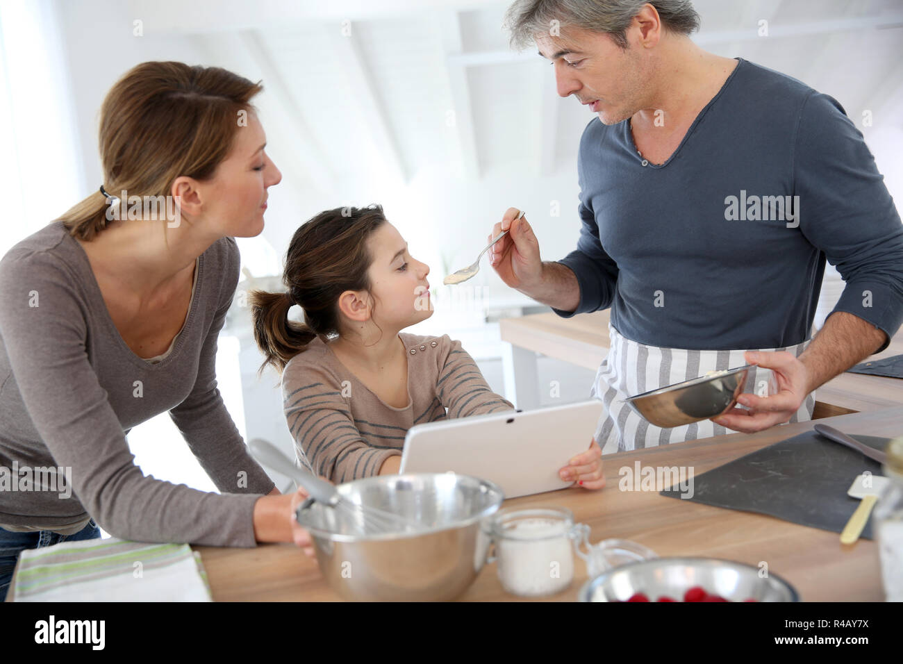 Family in home kitchen preparing pastry Stock Photo - Alamy