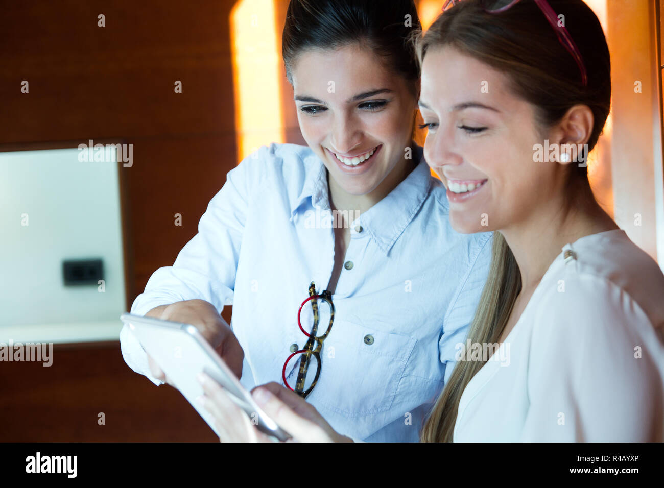 Two pretty business women working in the office Stock Photo - Alamy