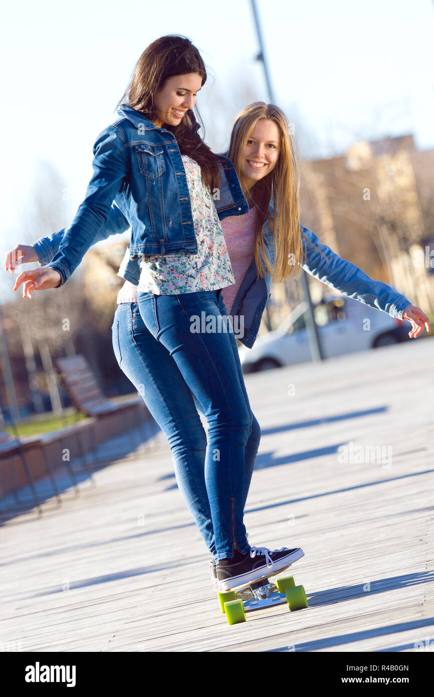 Two Friends having fun with skate Stock Photo - Alamy