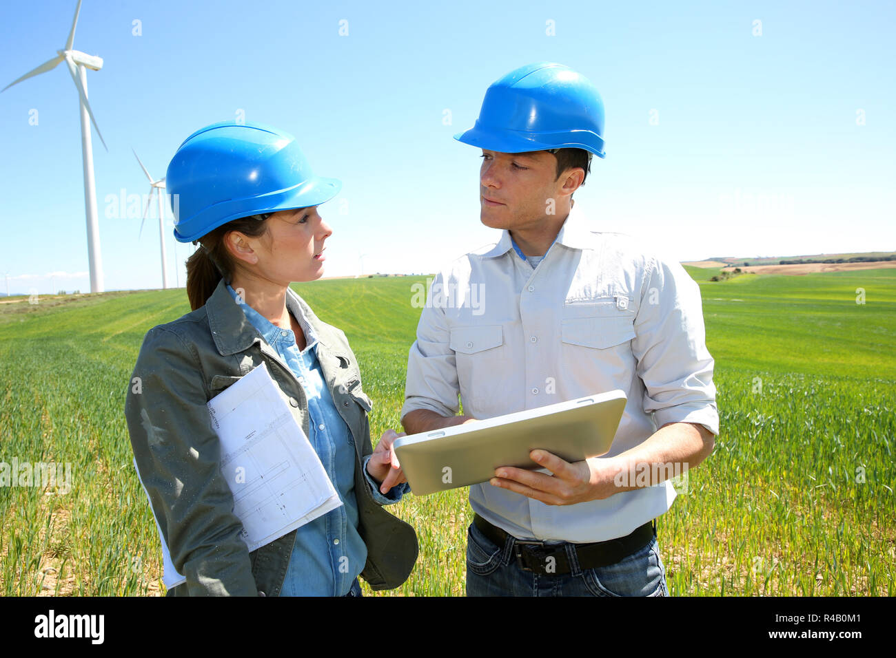 Engineers using tablet on wind turbine site Stock Photo - Alamy