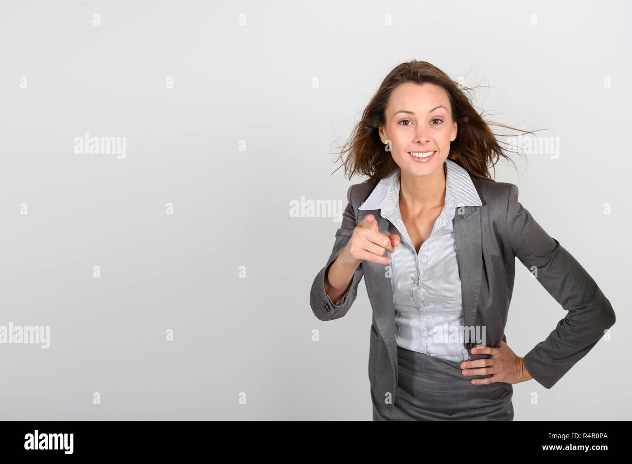 Smiling businesswoman pointing finger to camera Stock Photo - Alamy