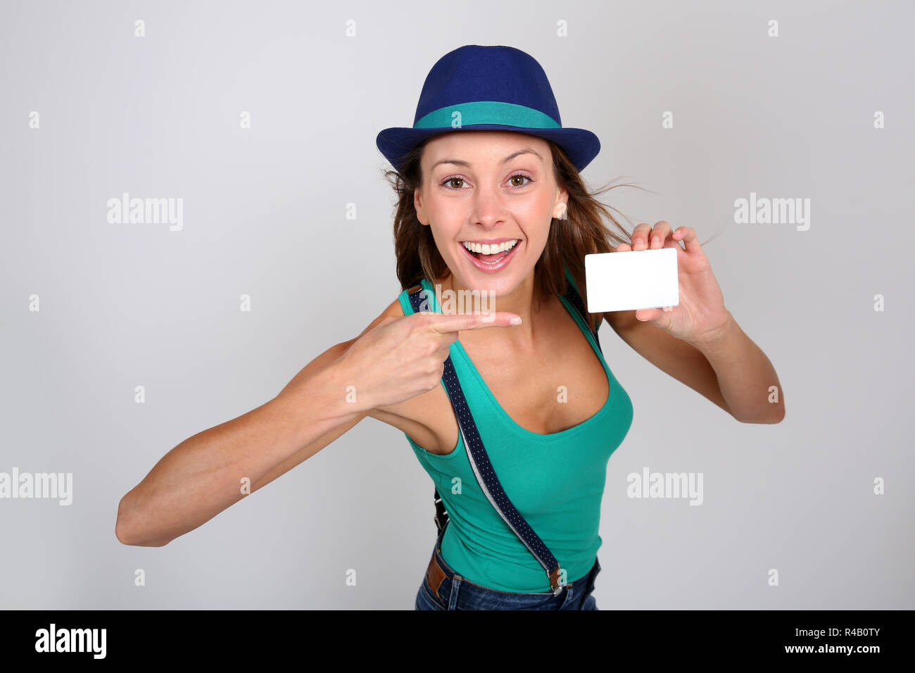 Beautiful stylish girl holding pass ticket Stock Photo - Alamy