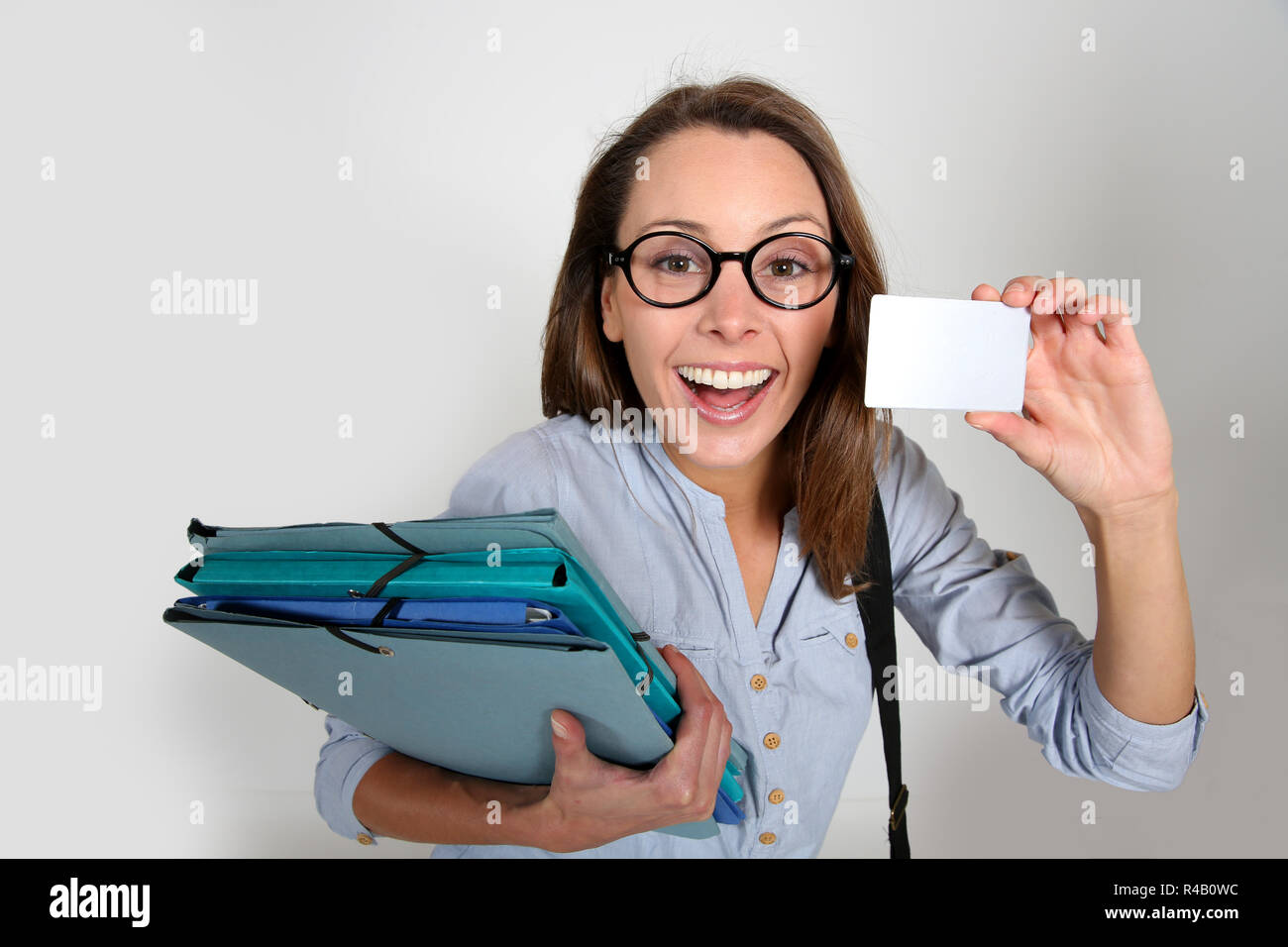 Smiling student girl showing college pass Stock Photo - Alamy