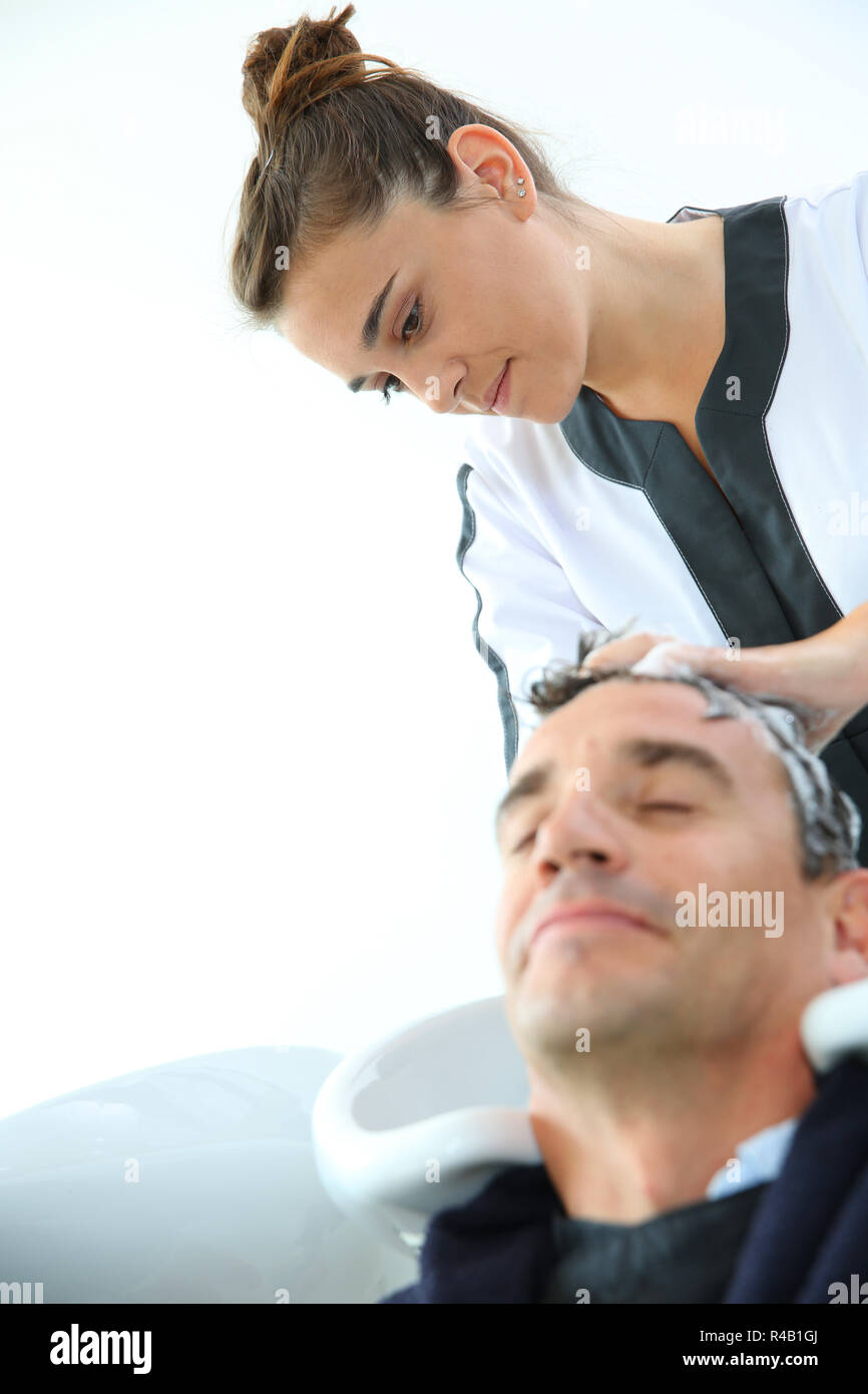 Young women in hairdress training washing customer's hair Stock Photo ...