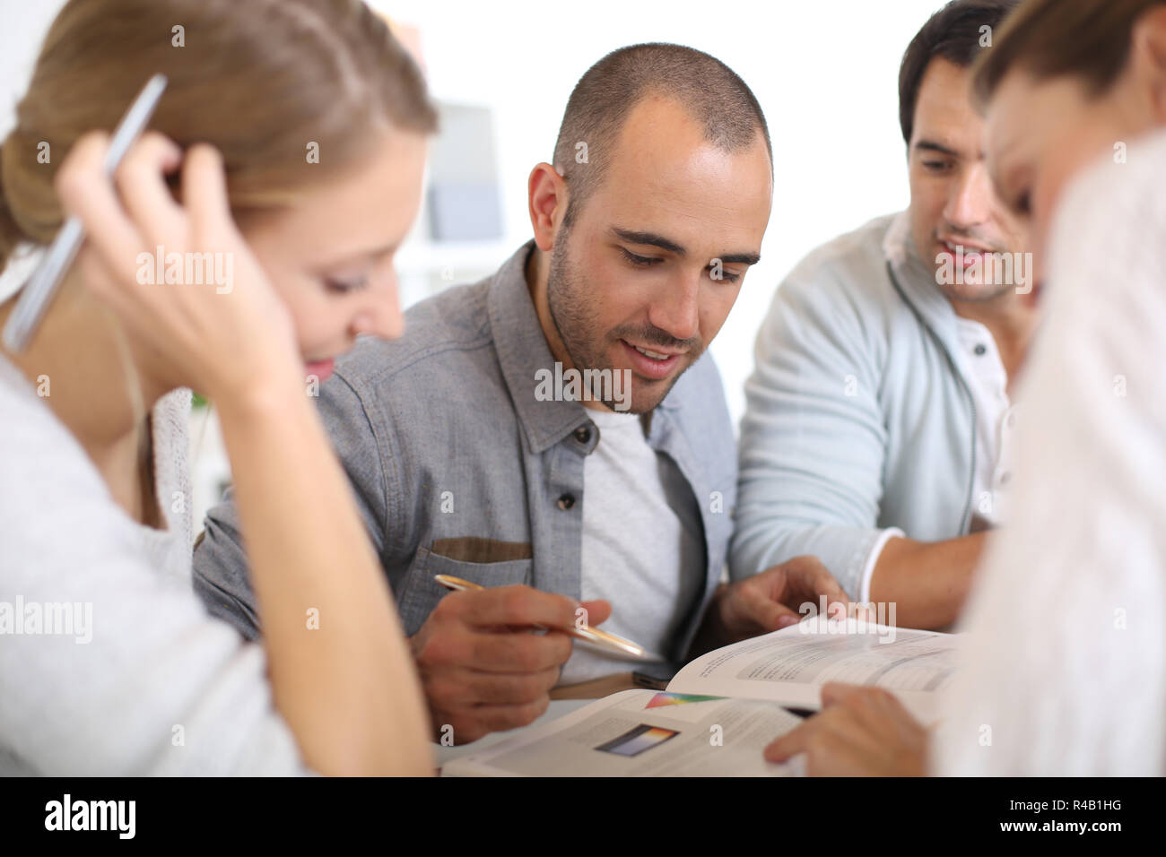 Young people in college studying together in library Stock Photo - Alamy