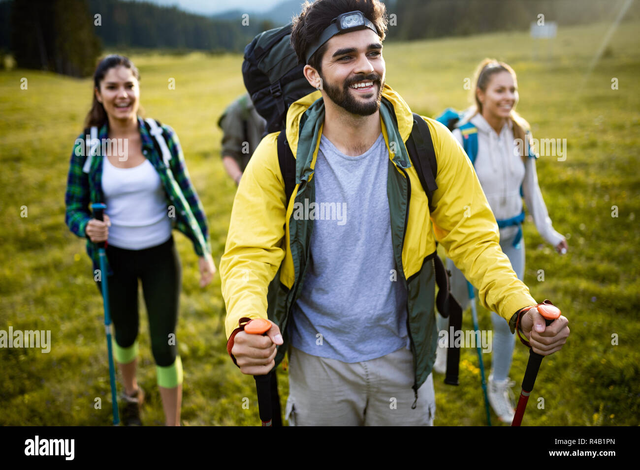 Group of hikers walking on a mountain and smiling Stock Photo - Alamy