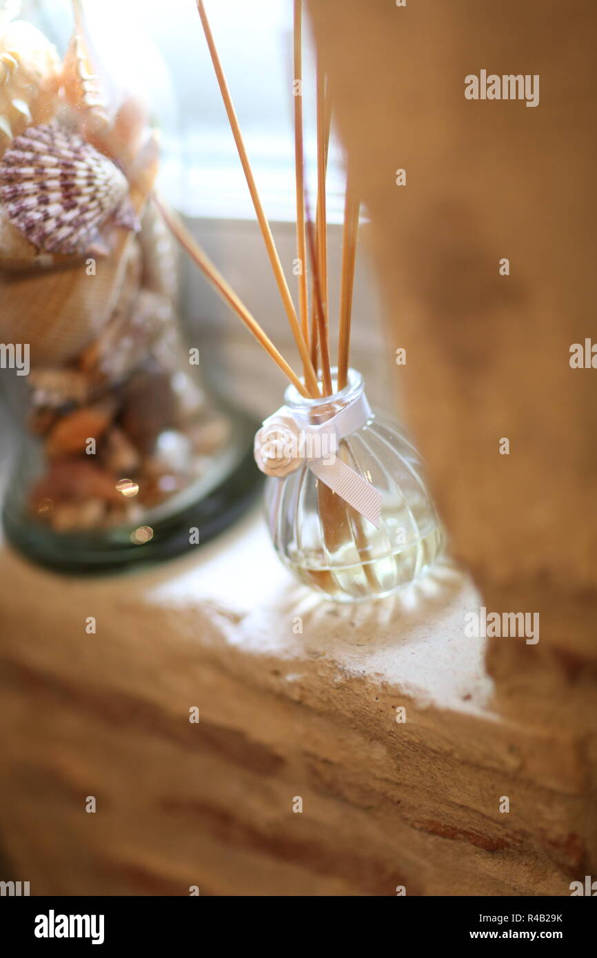 Scented sticks set in rustic bathroom Stock Photo - Alamy