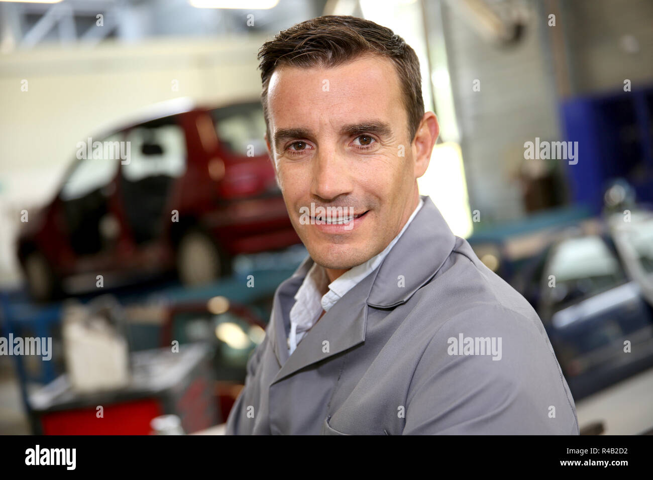 Portrait of coachbuilder standing in autoshop Stock Photo - Alamy