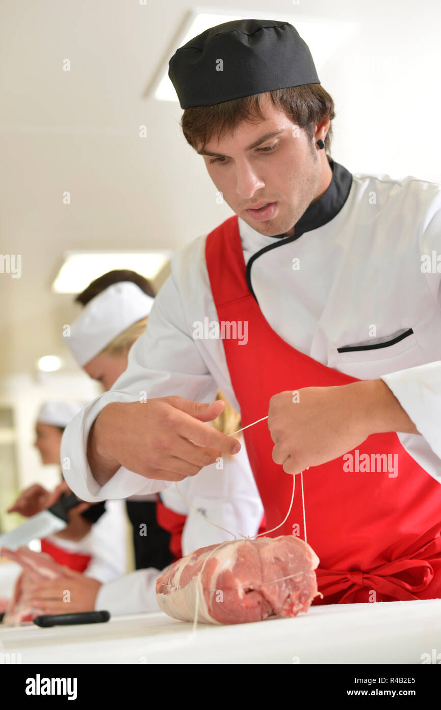 Young butcher in training class Stock Photo - Alamy