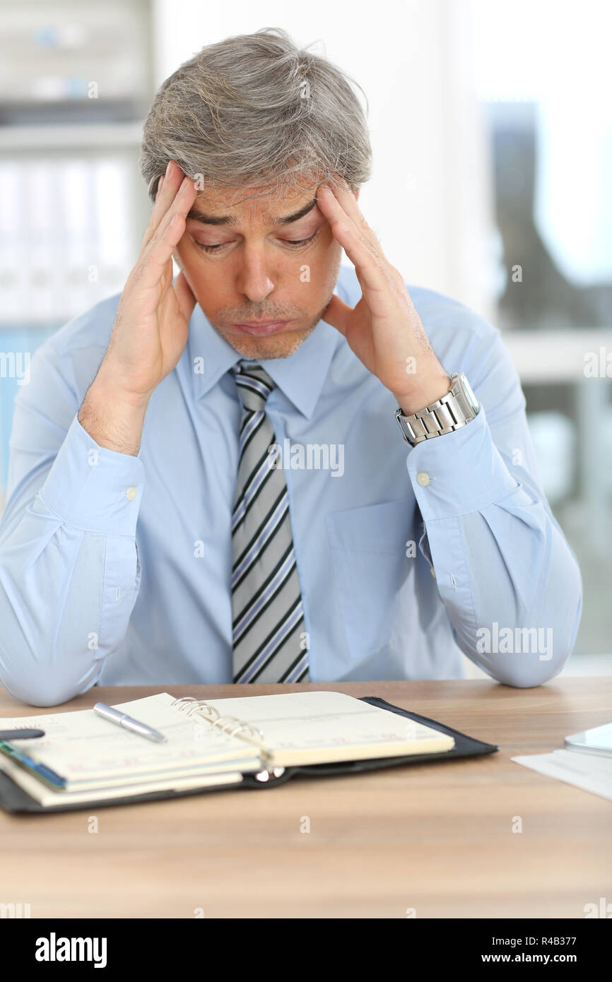 Businessman with tired expression on his face Stock Photo - Alamy