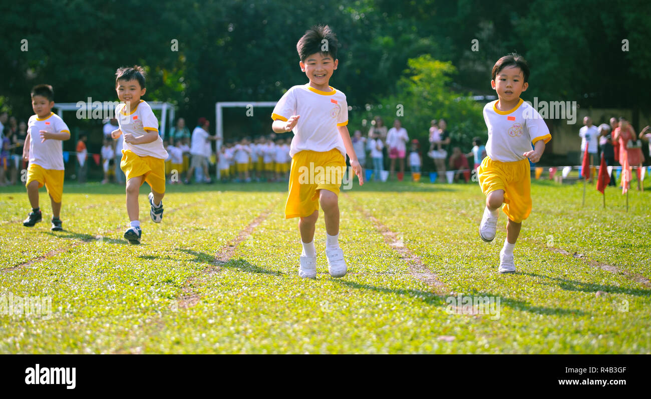 Children having fun competing to the finish line during their ...