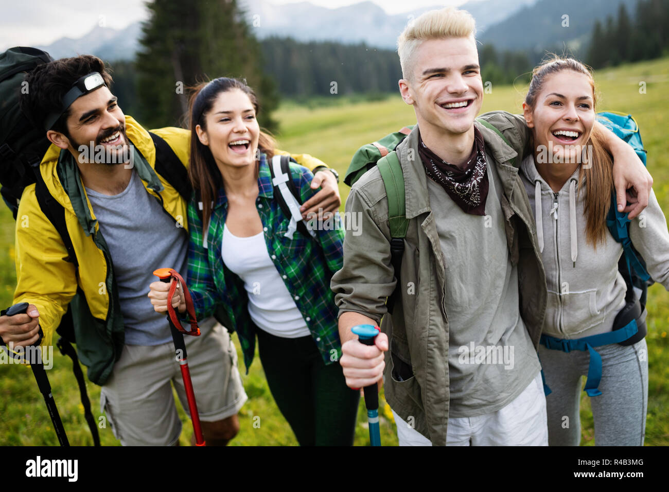Hiking with friends is so fun. Group of young people with backpacks ...