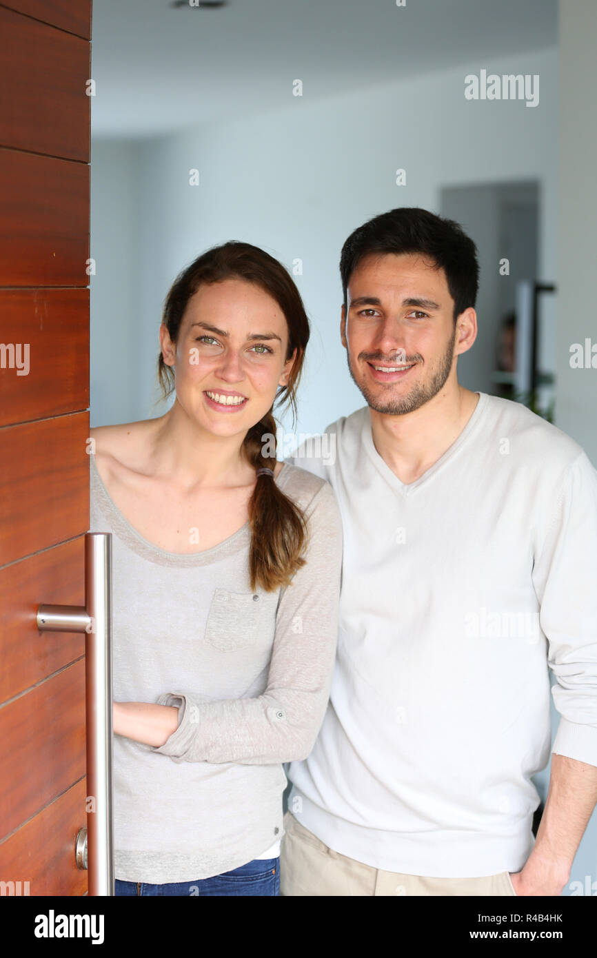 Happy couple opening new home entrance door Stock Photo - Alamy