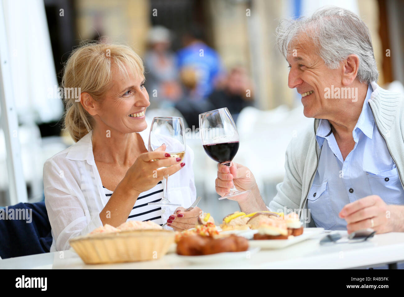 Senior couple eating Spanish fingerfood in Spain Stock Photo - Alamy