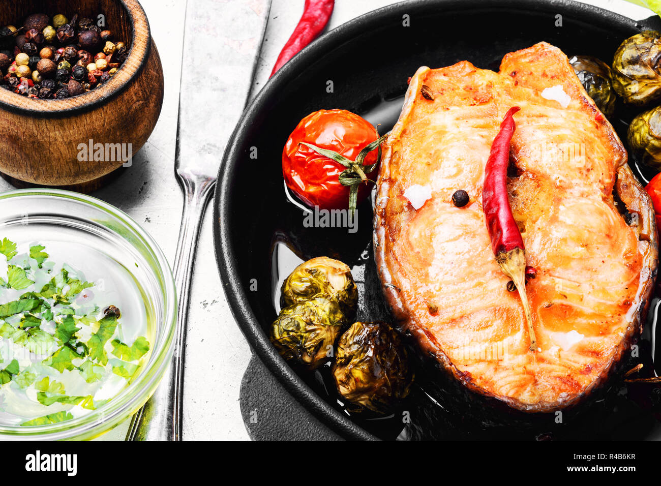 Grilled salmon with vegetables in a pan.Fish steak with vegetable ...