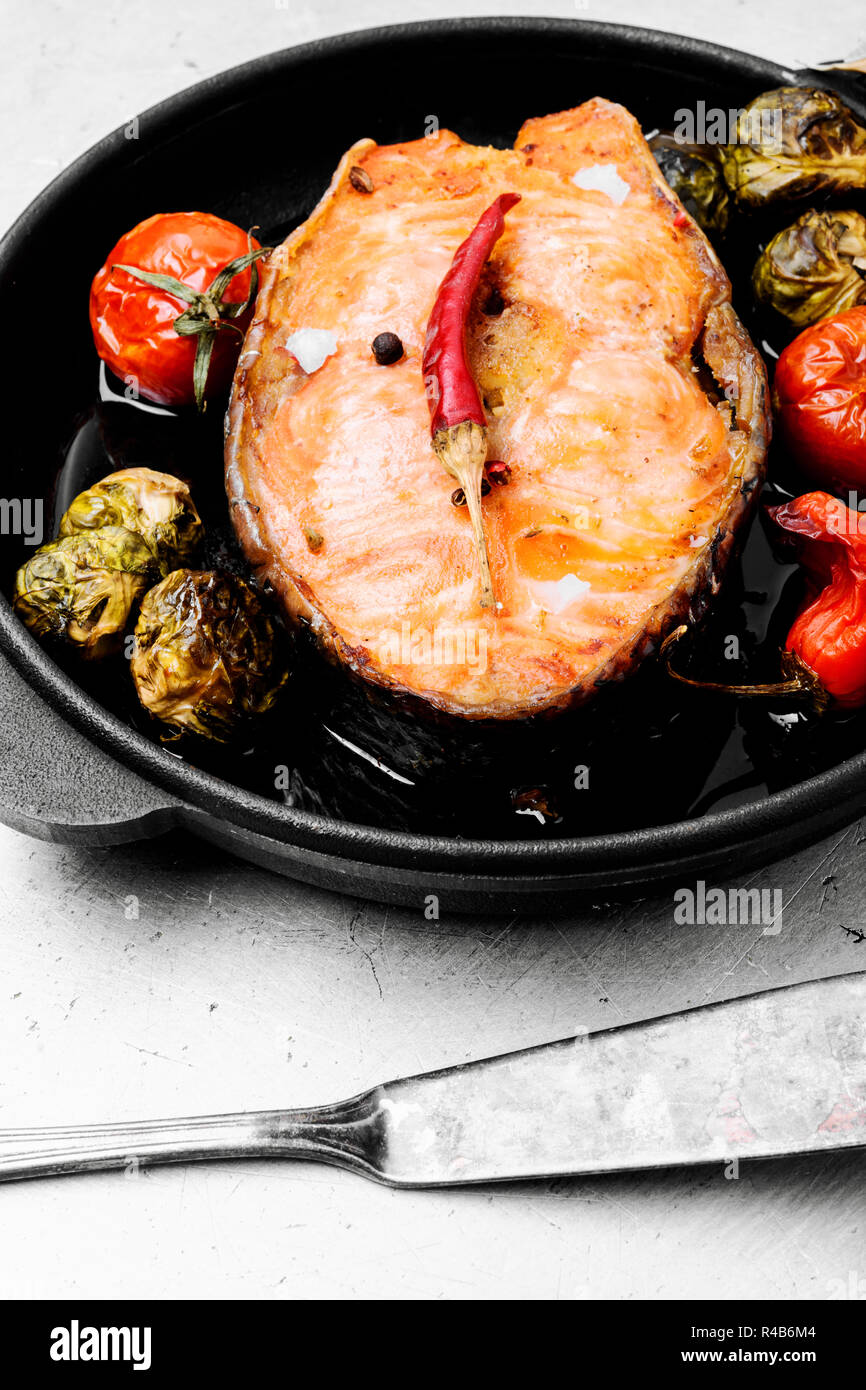 Grilled salmon with vegetables in a pan.Fish steak with vegetable ...