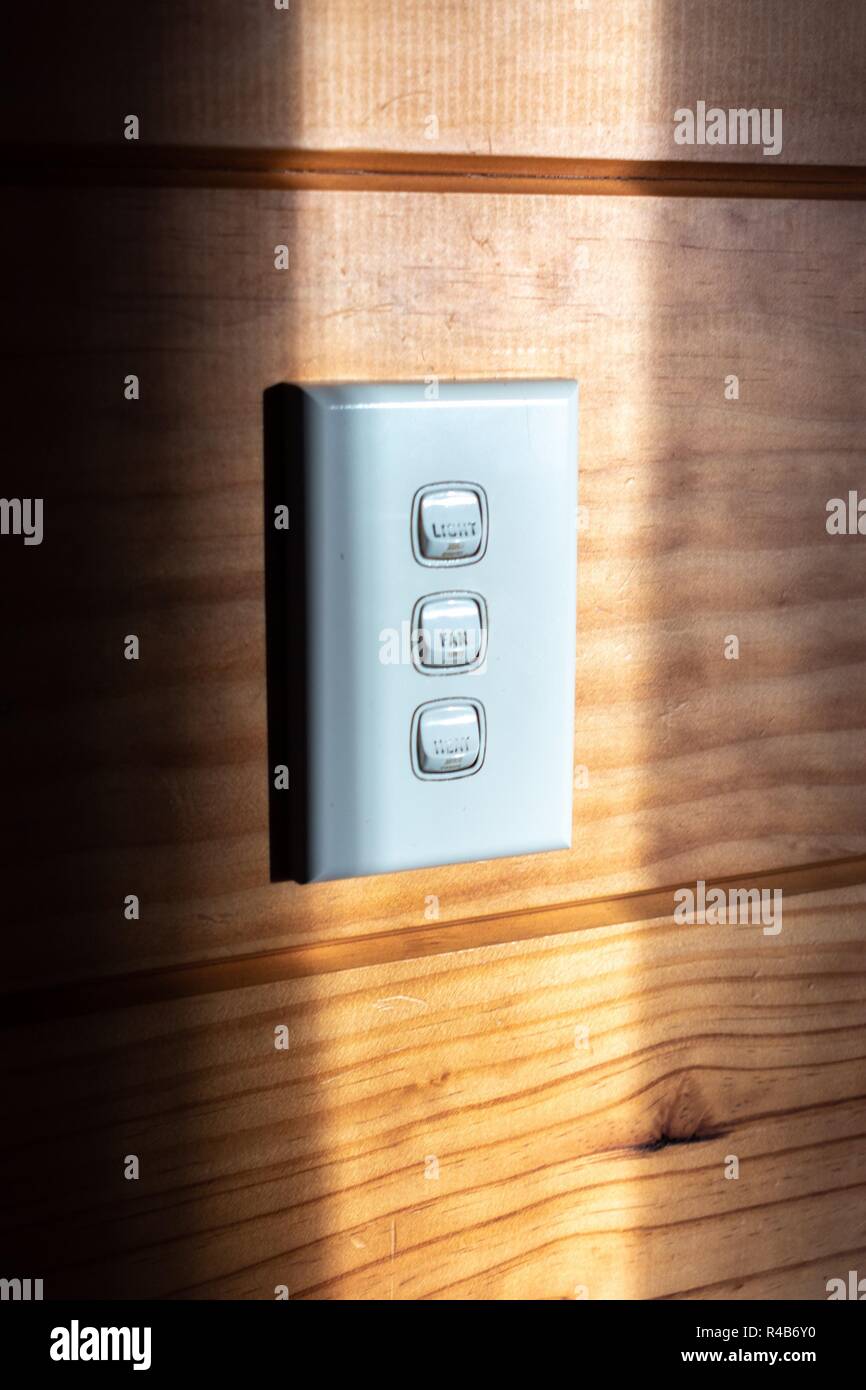 Vertical image of White Light Switch panel on a timber wall Stock Photo ...