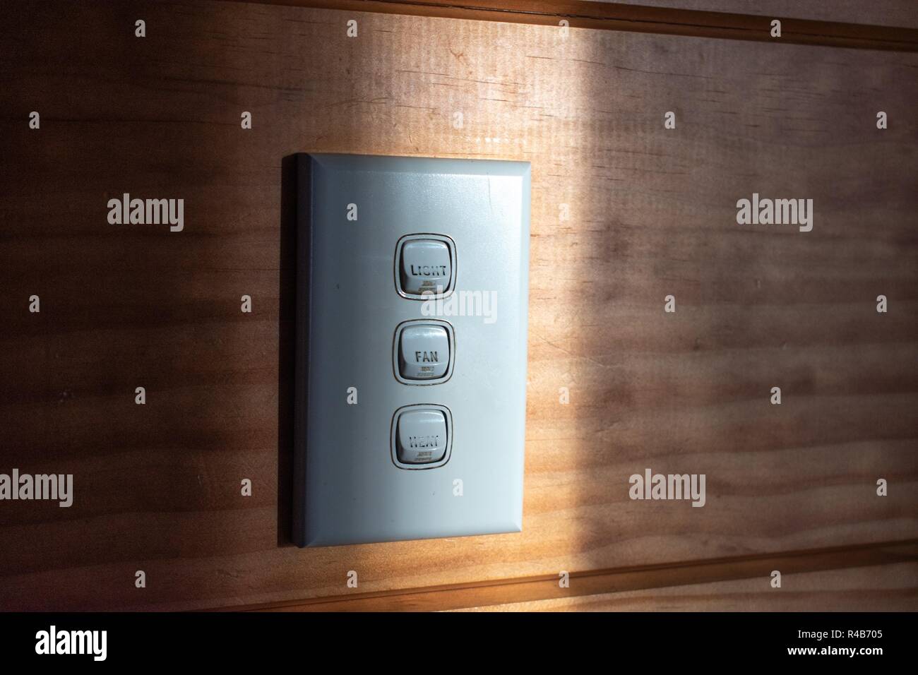 Horizontal image of White Light Switch panel on a timber wall Stock ...