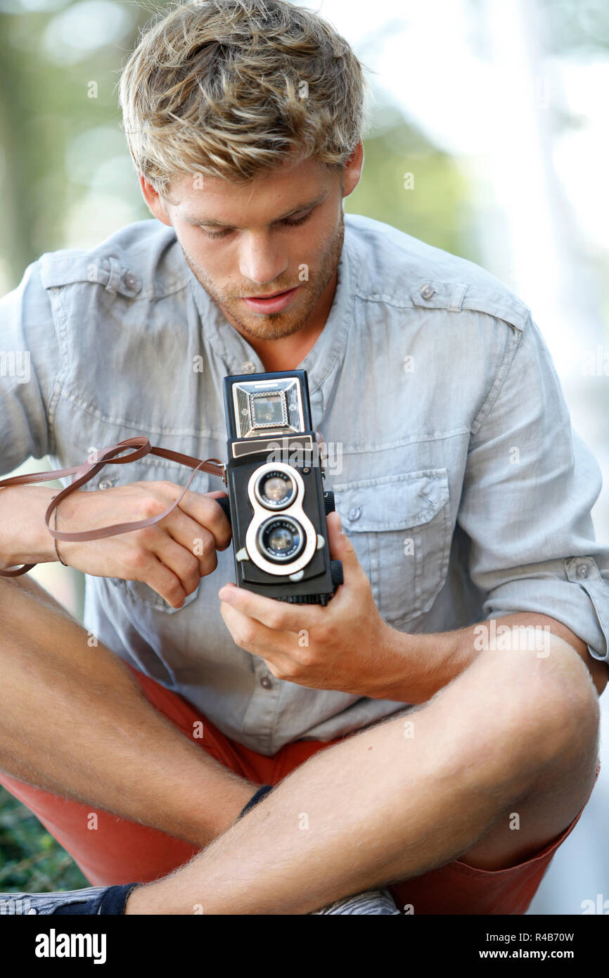 Trendy photographer using vintage camera Stock Photo - Alamy