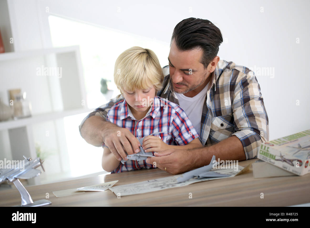 Father and kid making a plane model Stock Photo - Alamy