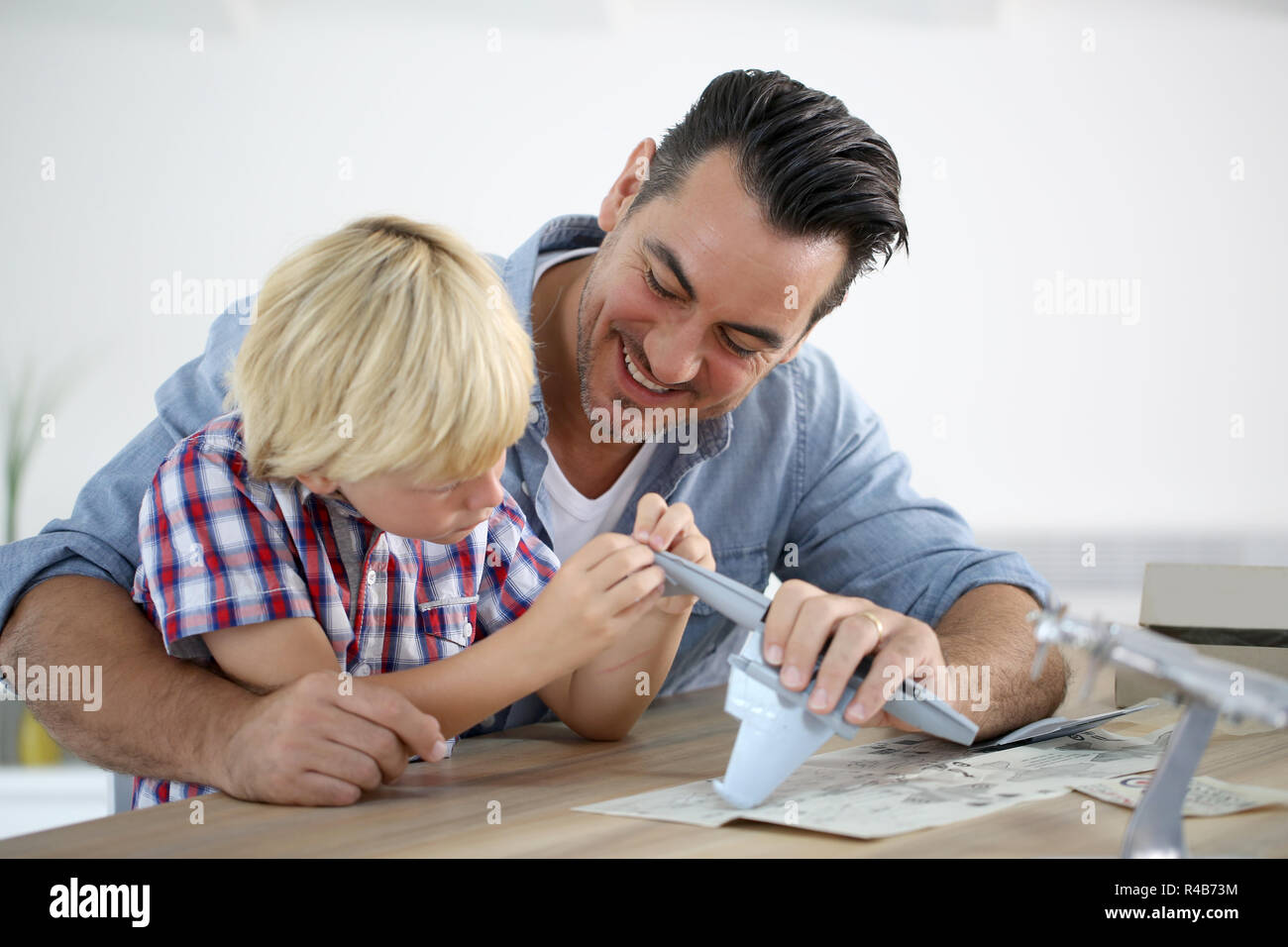 Father and kid making a plane model Stock Photo - Alamy