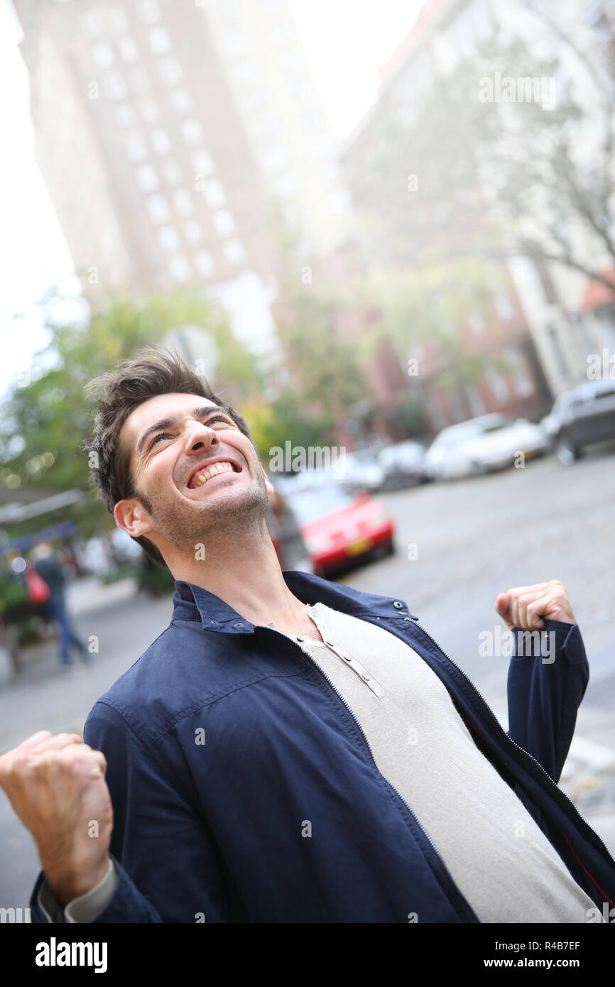 Man expressing happiness and success in the street Stock Photo - Alamy