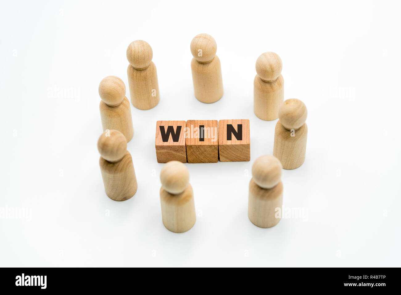 Wooden figures as business team in circle around word WIN, isolated on ...