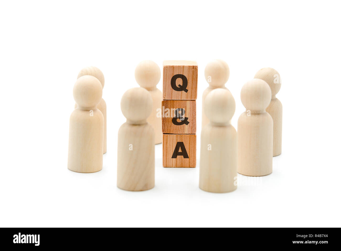 Wooden figures as business team in circle around acronym Q&A Questions ...