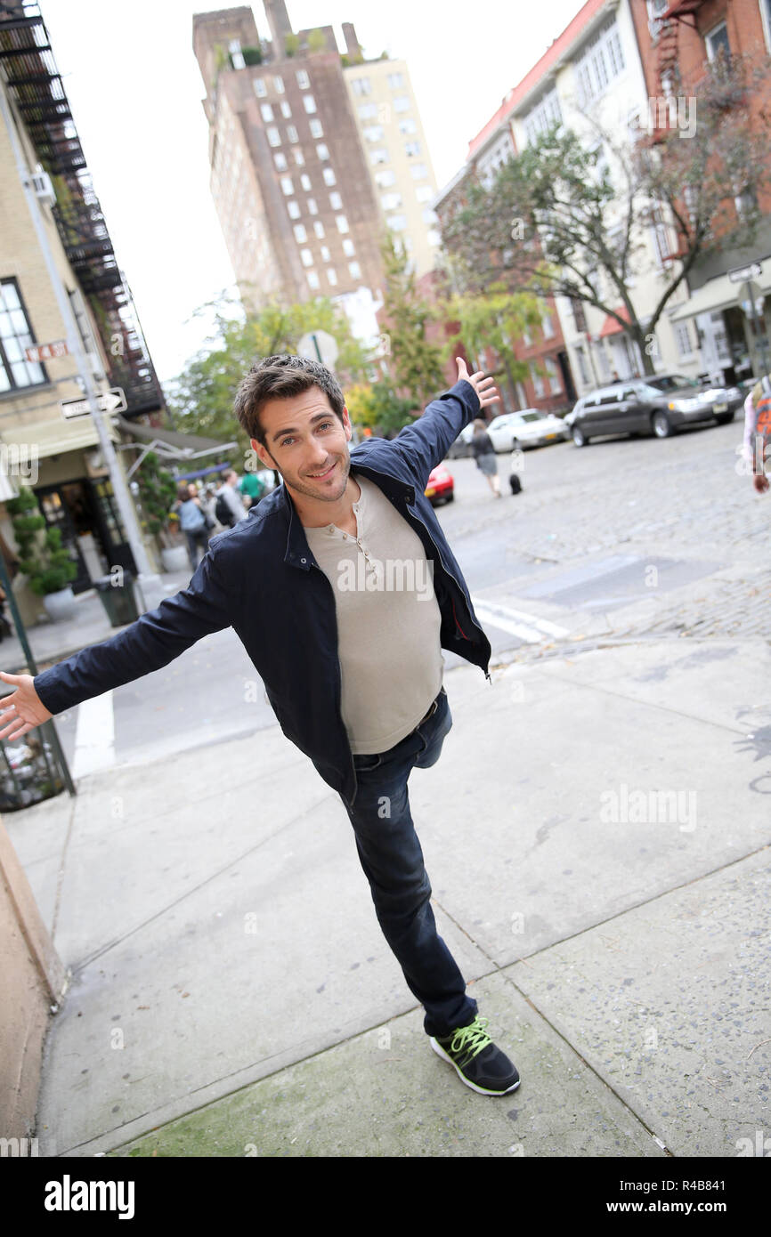 Man in new York city stretching arms out Stock Photo - Alamy