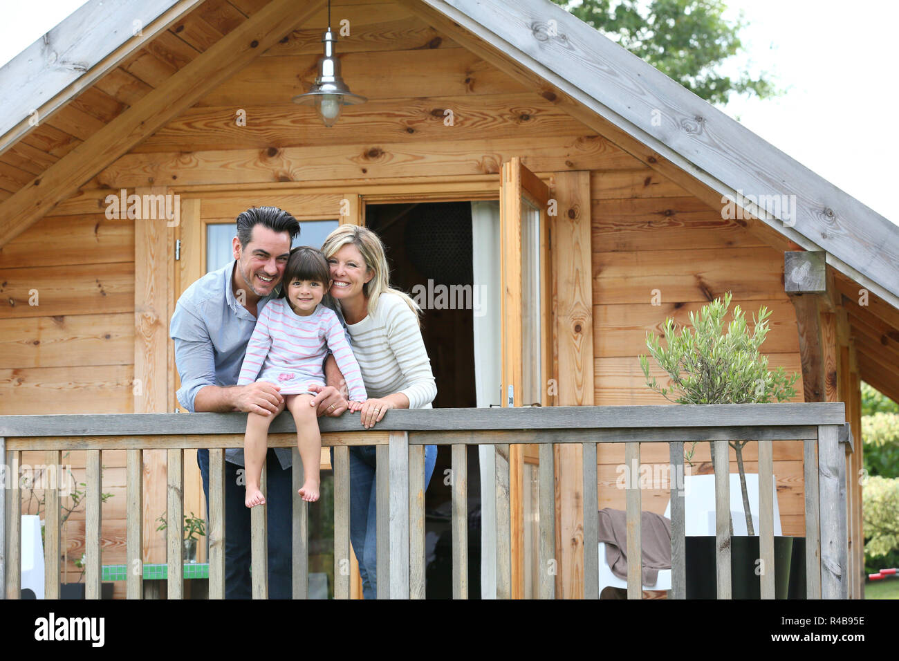 Family enjoying vacation in log cabin Stock Photo - Alamy
