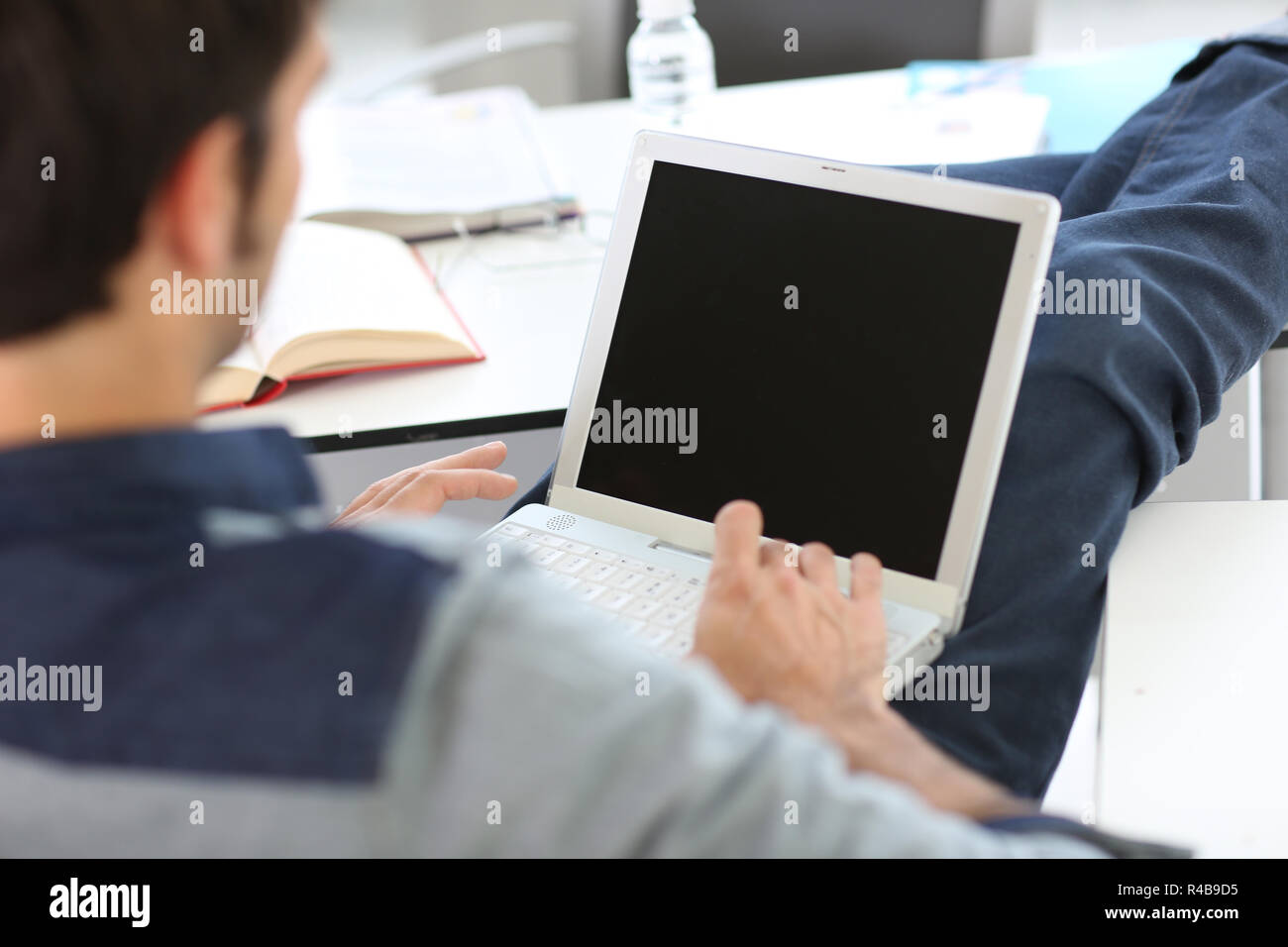 Student in campus relaxing with laptop Stock Photo - Alamy