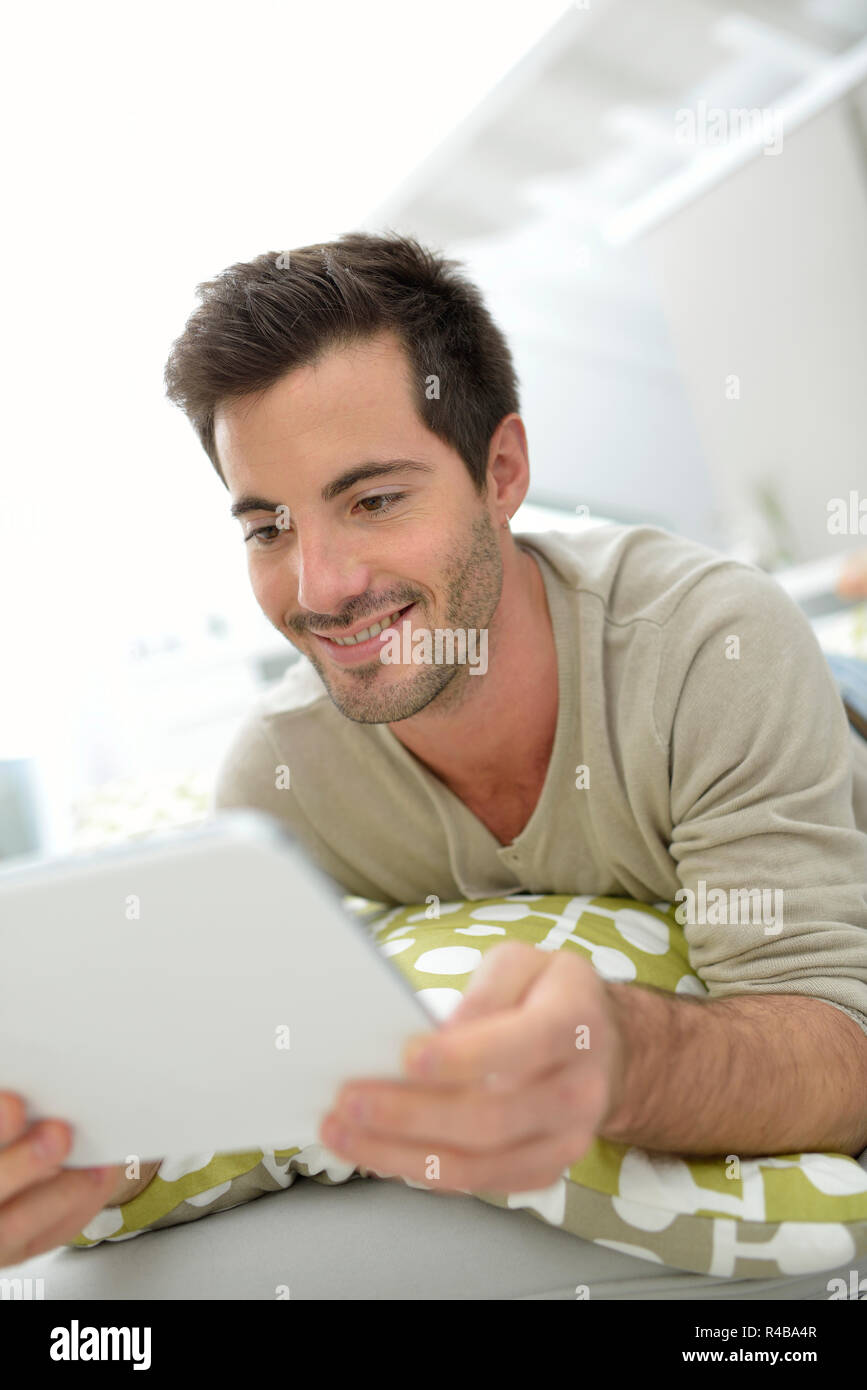 Man websurfing on internet with tablet Stock Photo - Alamy