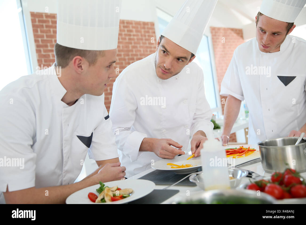 Chef training students in restaurant kitchen Stock Photo - Alamy