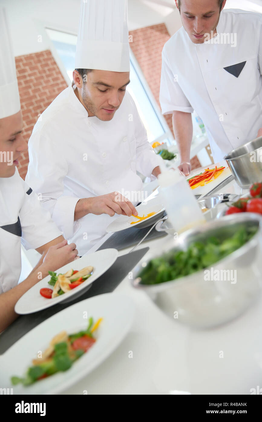 Chef training students in restaurant kitchen Stock Photo - Alamy