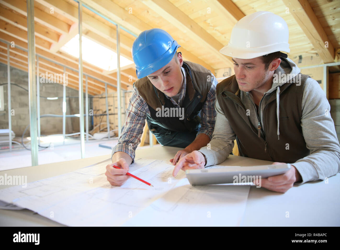 Young men in professional training working on building site Stock Photo ...