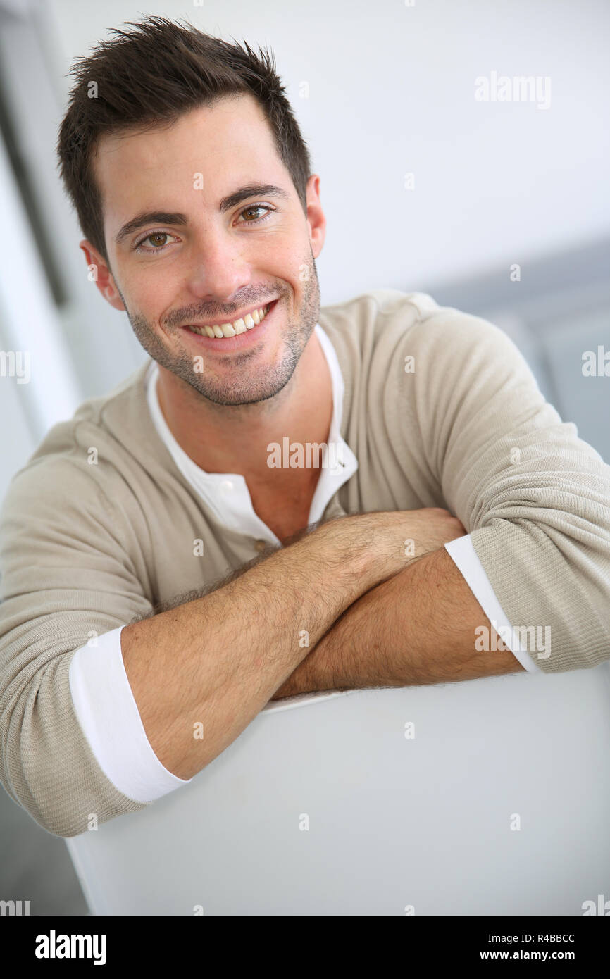 Smiling man relaxing at home Stock Photo - Alamy