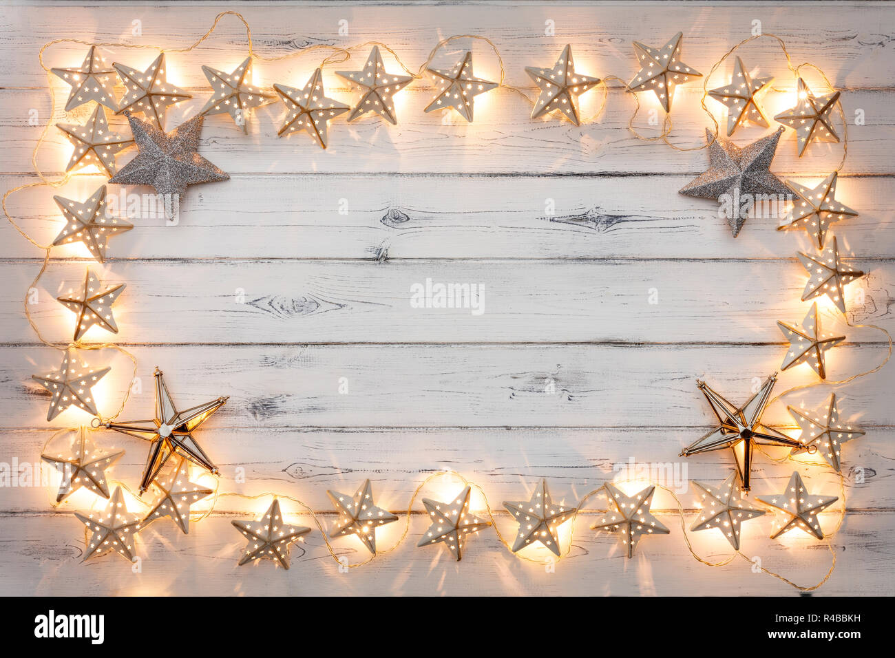 A string of golden star christmas lights, and star baubles, on a ...