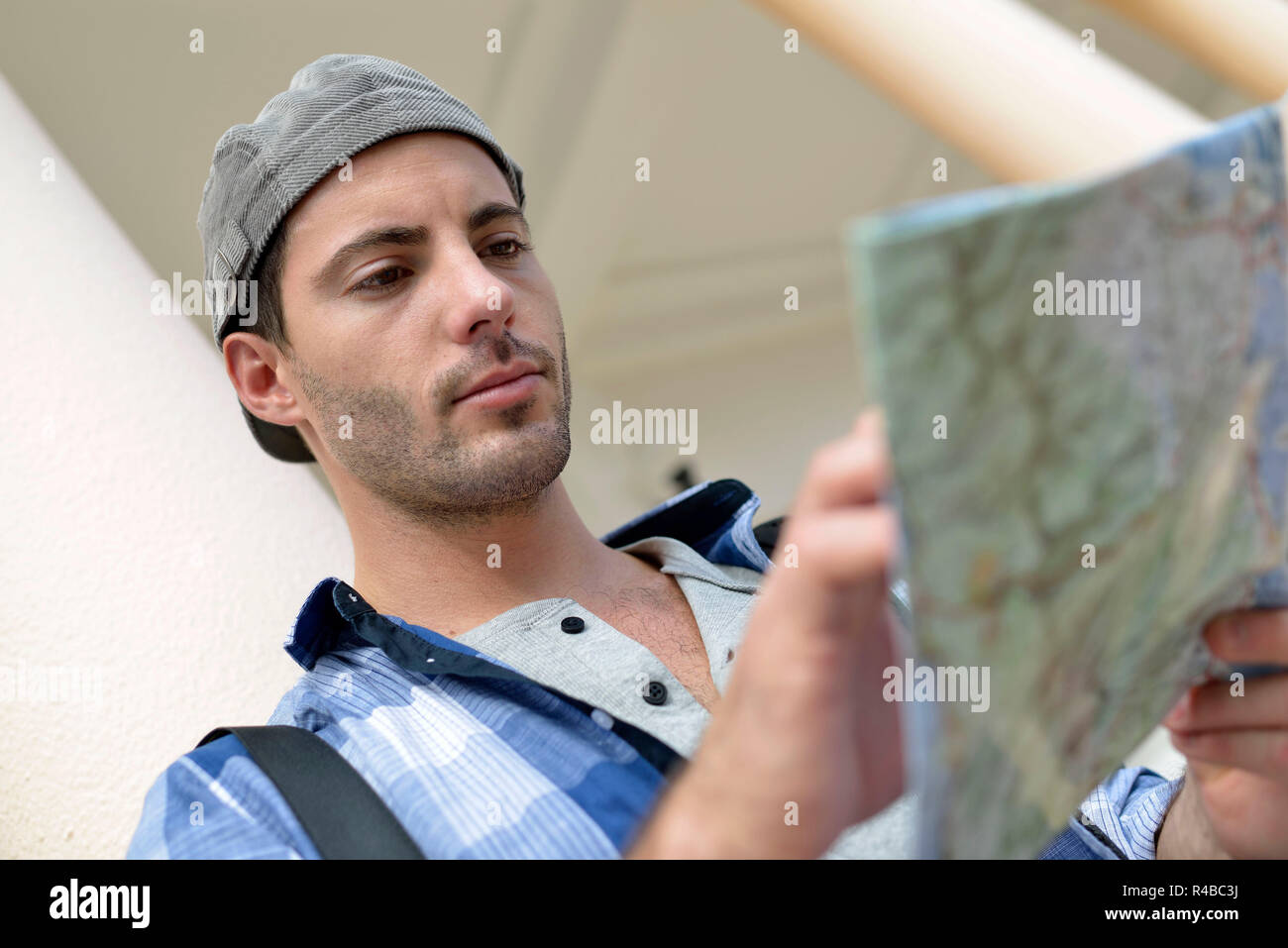 Adventurer looking at street map Stock Photo - Alamy