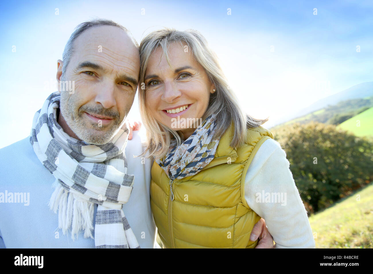 Portrait of happy senior couple in winter landscape hi-res stock ...